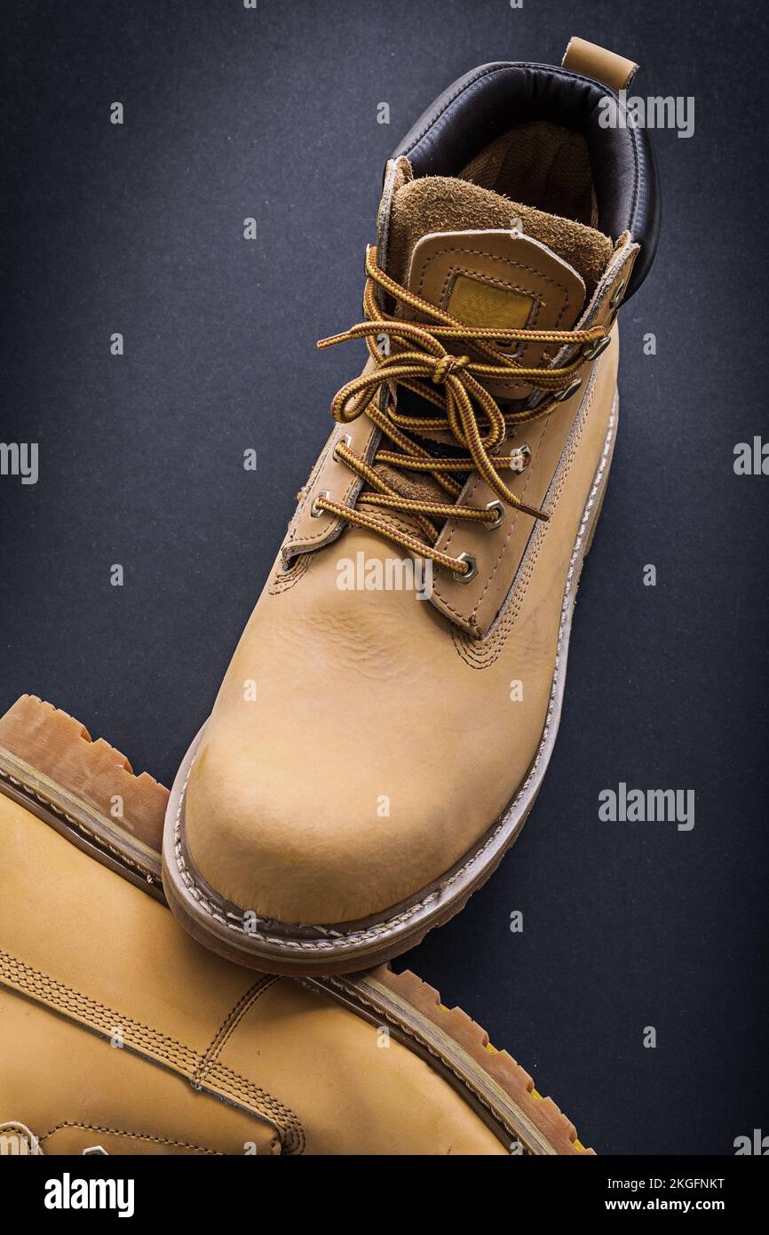 working boots on black background Stock Photo - Alamy