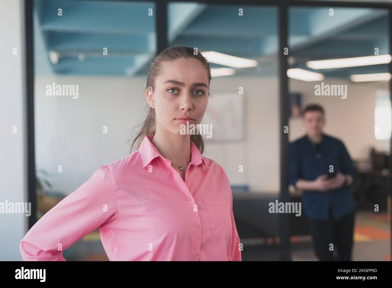 Portrait Of Young Smiling Business Woman In Creative Open Space