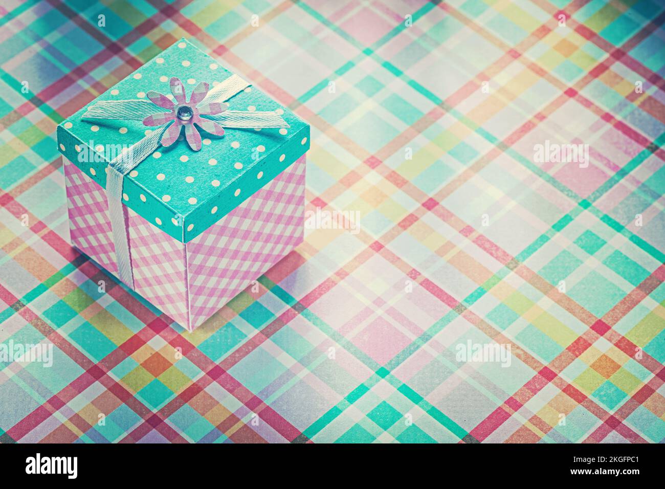 Wrapped present box on checked fabric background holidays concept Stock ...