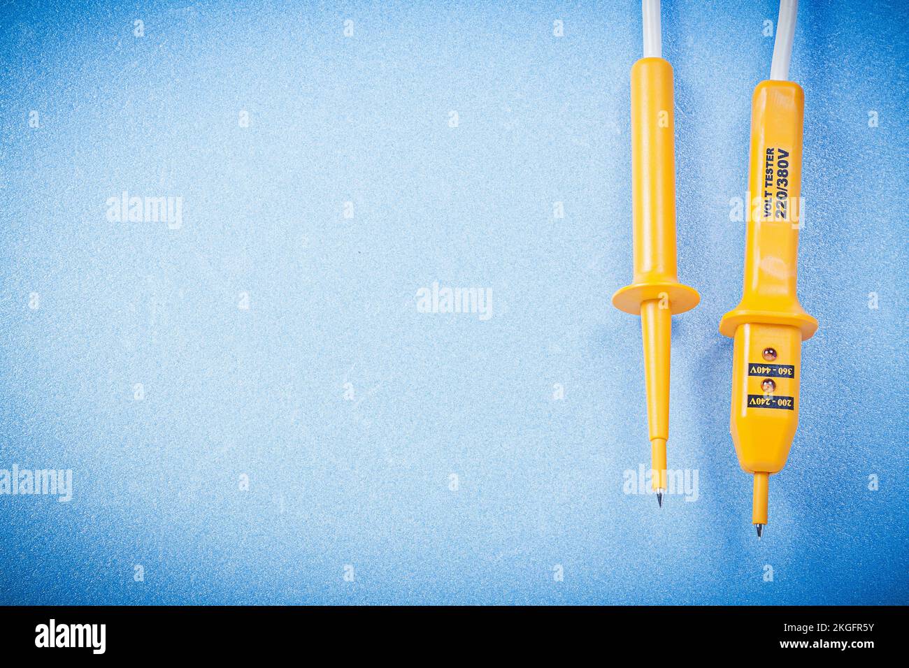 Yellow electric tester on blue background copy space electricity ...