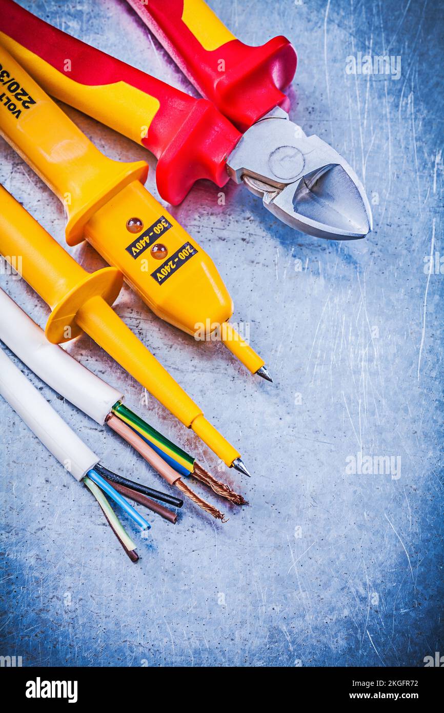 Yellow electrical tester wires cutting pliers on metallic background ...