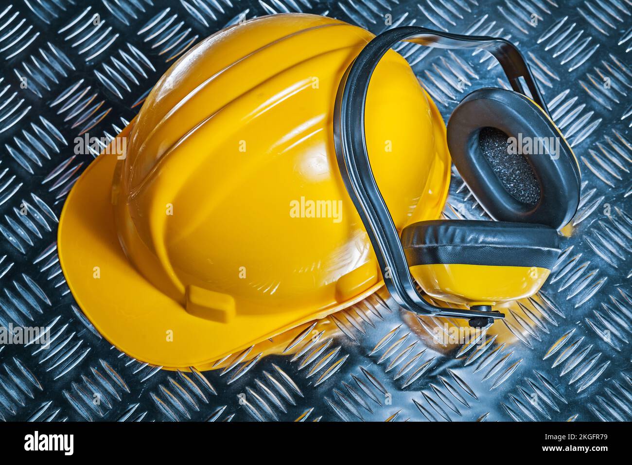 yellow helmet and earphones on corrugated sheet of metal Stock Photo ...