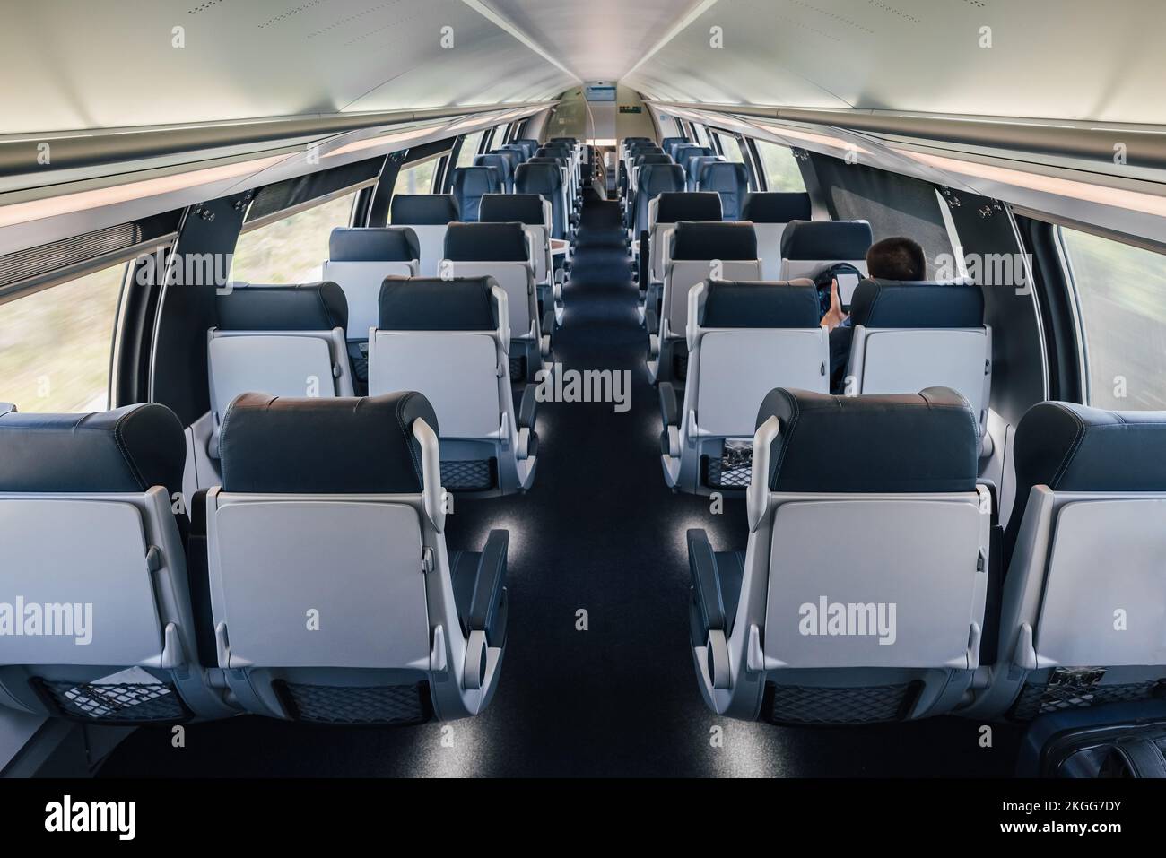 High angle view of passenger using mobile phone. Rows of seats in ...