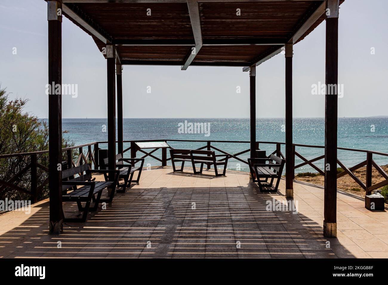 The empty benches against the background of the bluish-turquoise sea ...