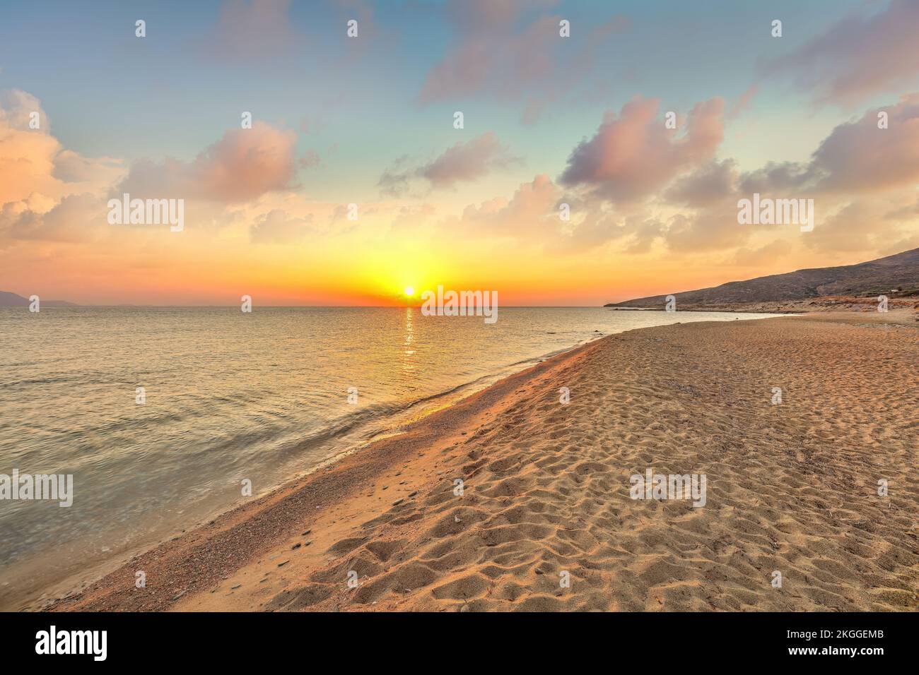 The sunrise from the sandy beach Psathi in Ios island, Greece Stock ...