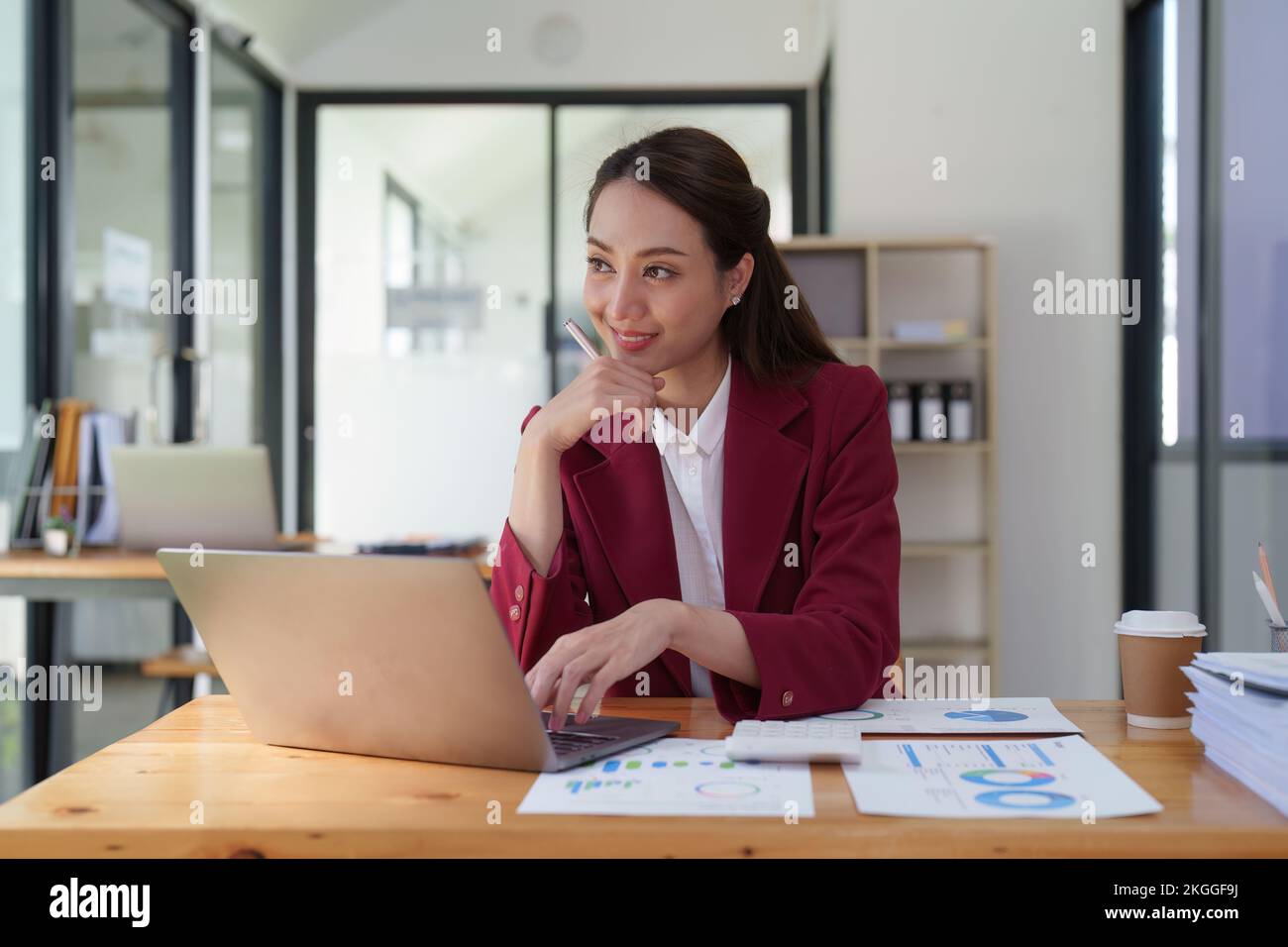Female employee using laptop at workplace. Businesswoman preparing ...