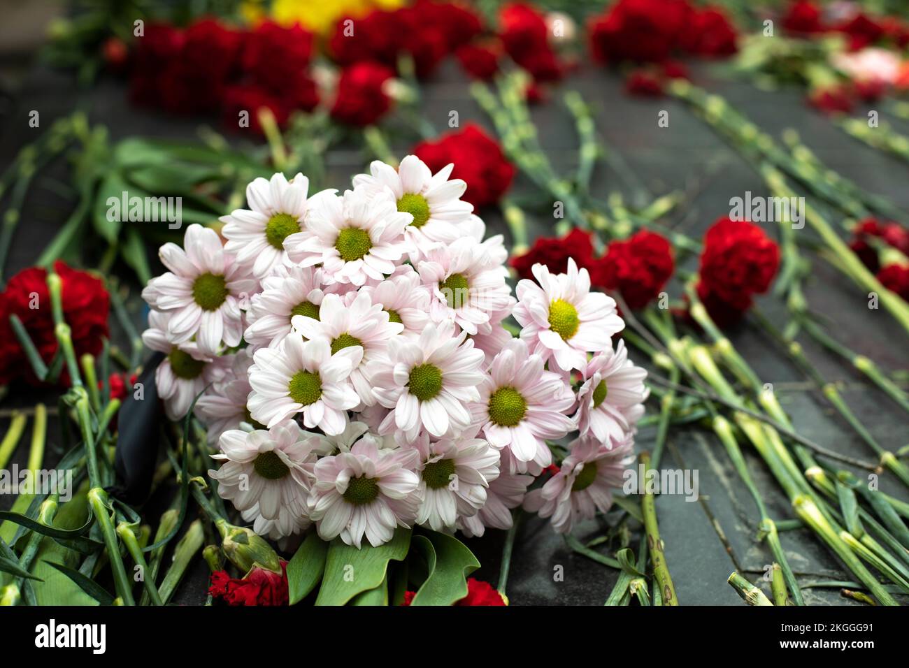 Flowers on memorial. Bouquet of flowers on gravestone. Details of ...