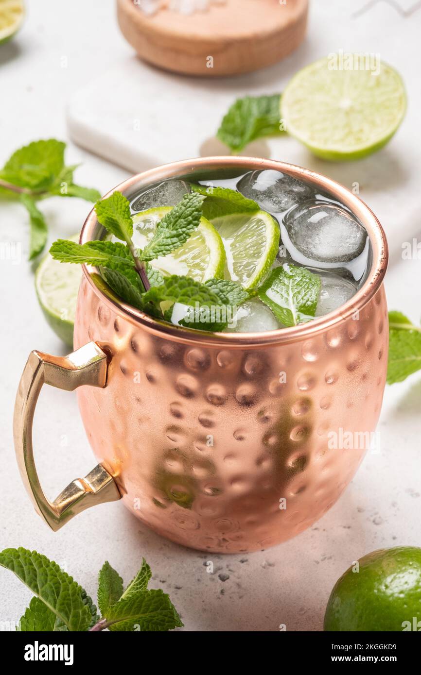 Moscow mule alcoholic cocktail in copper mug with lime, mint and ...