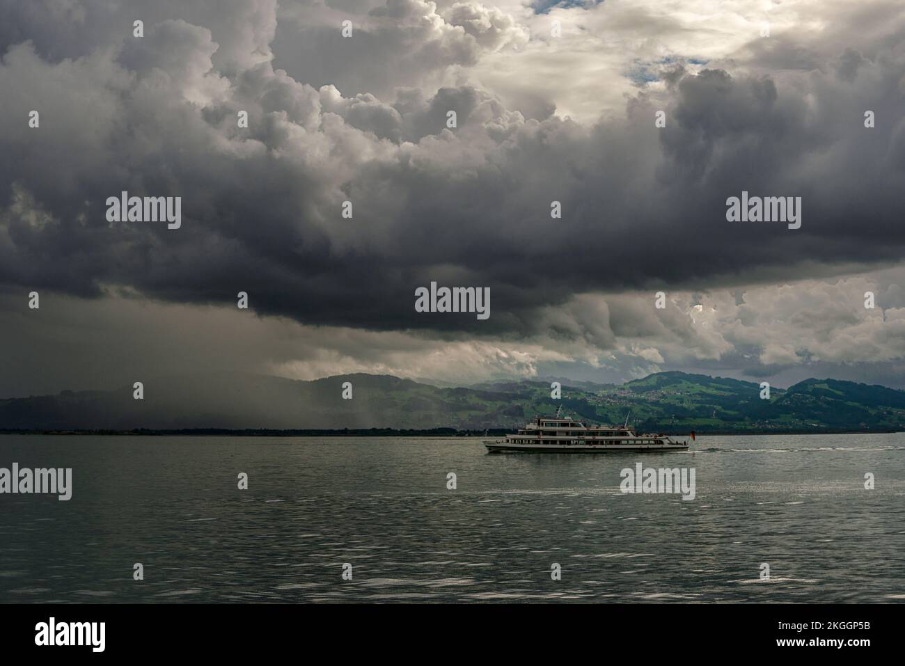 A beautiful cene of a ship in the middle of the sea under gray cloudy ...