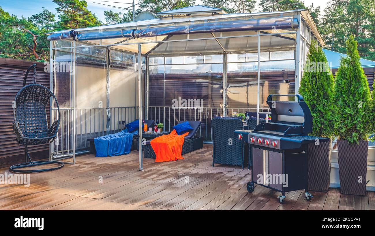 Wooden outdoor terrace of private house with canopy. Modern grill Stock ...