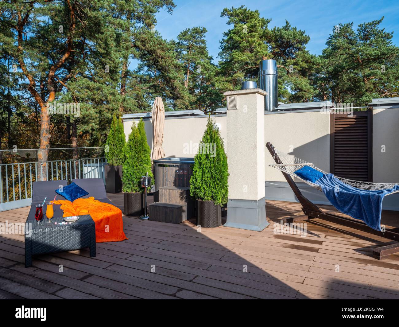 Outdoor terrace of luxury private house. Hammock, bath tub, sunbed ...
