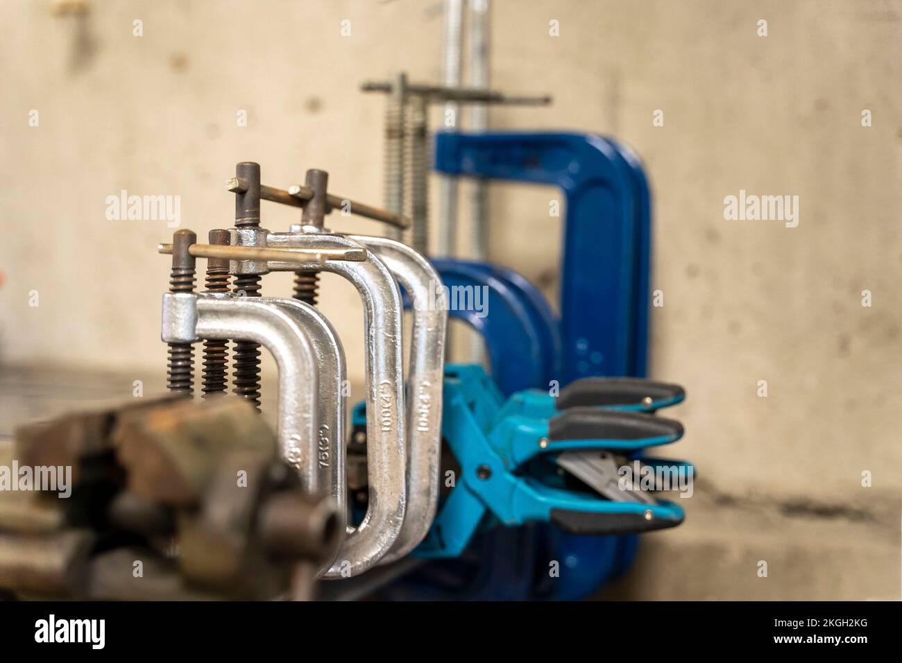 hand clamps on the welding table in the auto repair shop Stock Photo ...