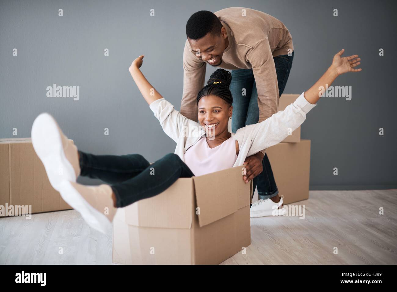 Couple, box and moving into real estate, home and fun while unpacking ...