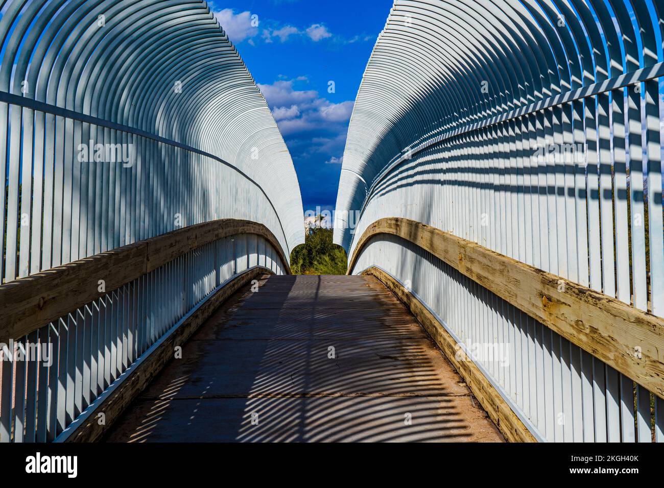 A symmetrical white pedestrian bridge Stock Photo - Alamy