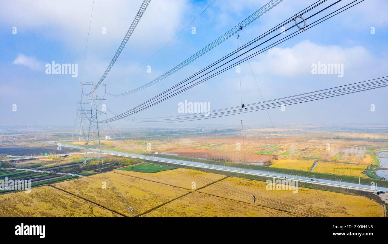 Aerial photos show the construction workers erecting new conductors at ...