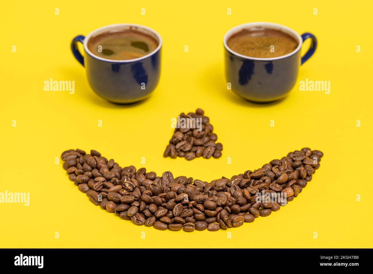 Smiling emoticon, lips made of coffee beans and eyes made of coffee ...