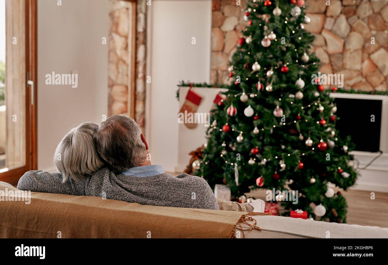 Senior couple, christmas and hug from back view relax on sofa in living ...