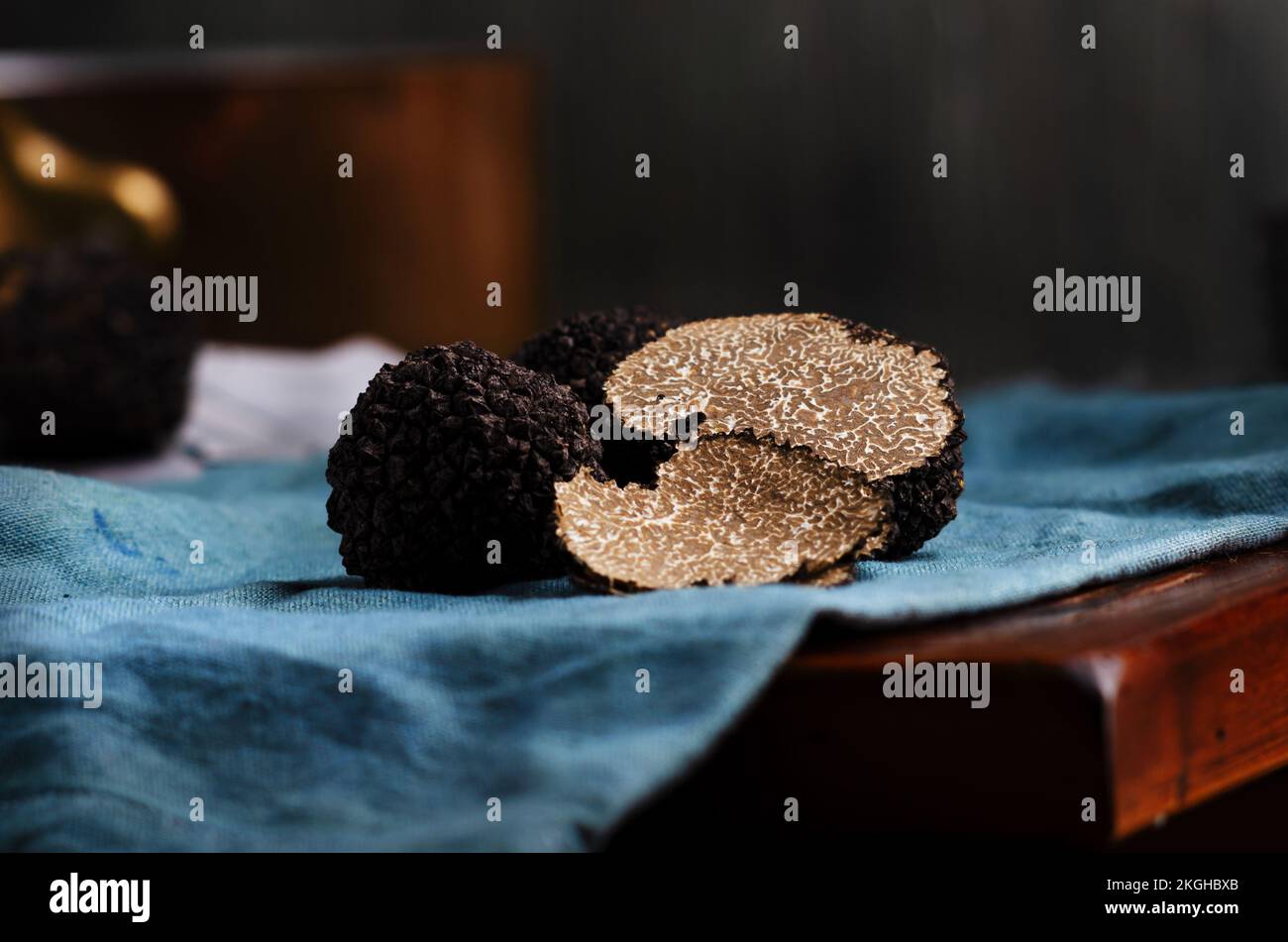 Cut black truffles on dark brown vintage background. Selective focus ...