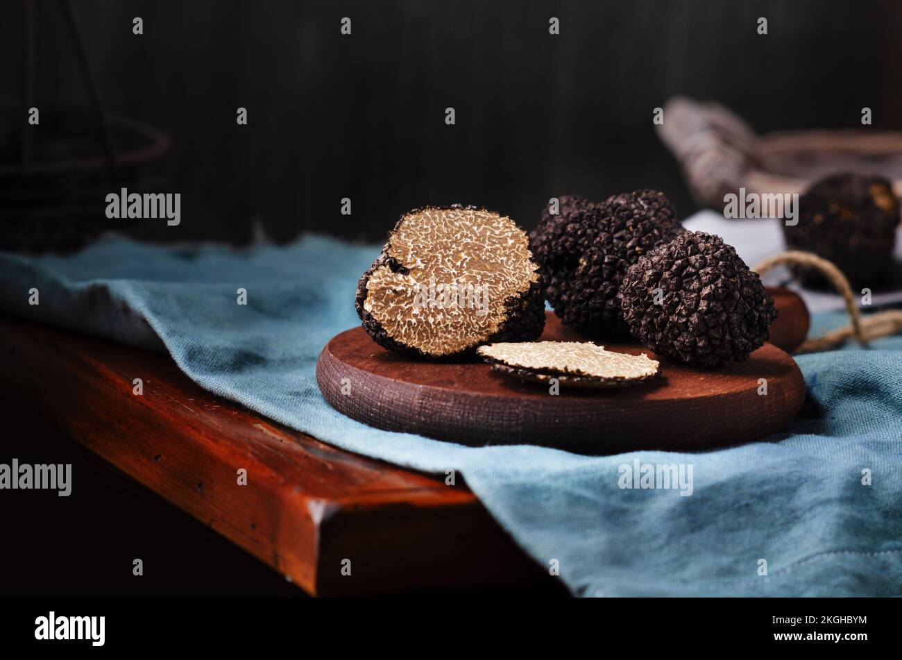 Cut black truffles on dark brown vintage background. Selective focus ...