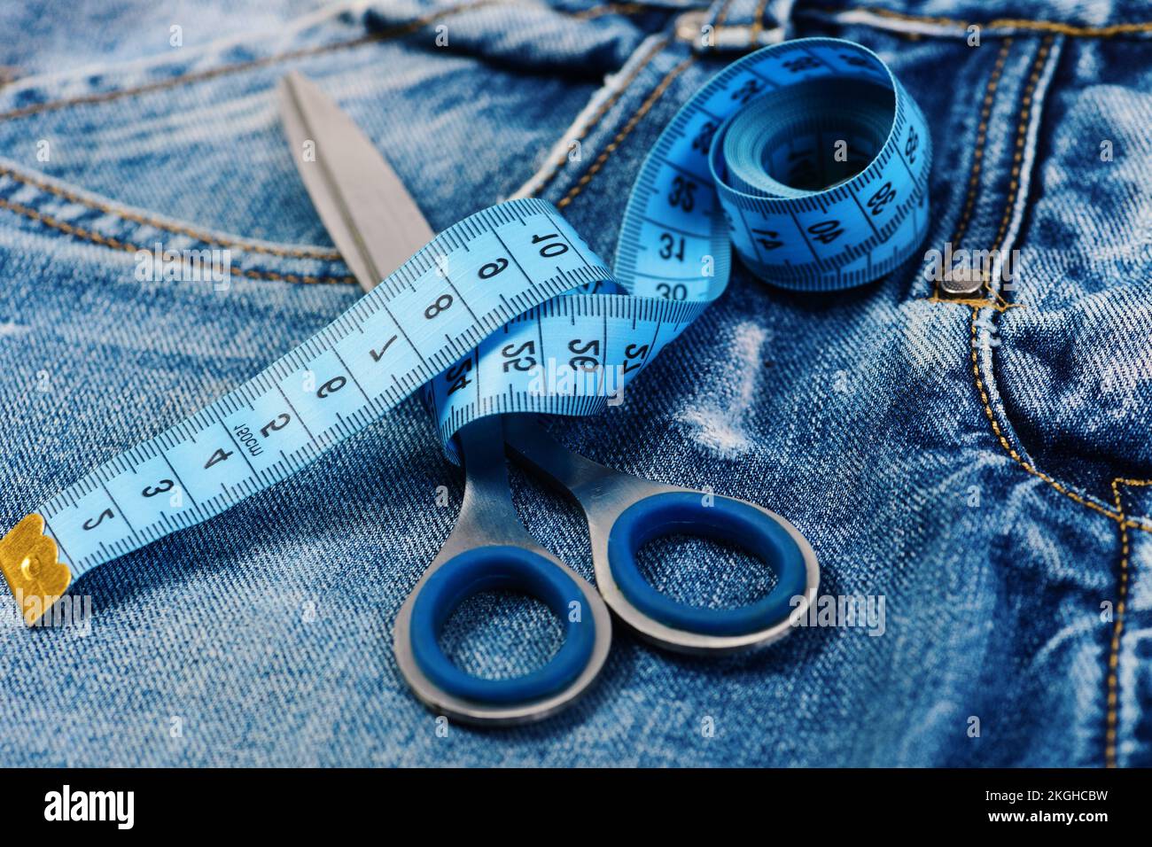 Measure tape wound around metal scissors as making clothes concept ...