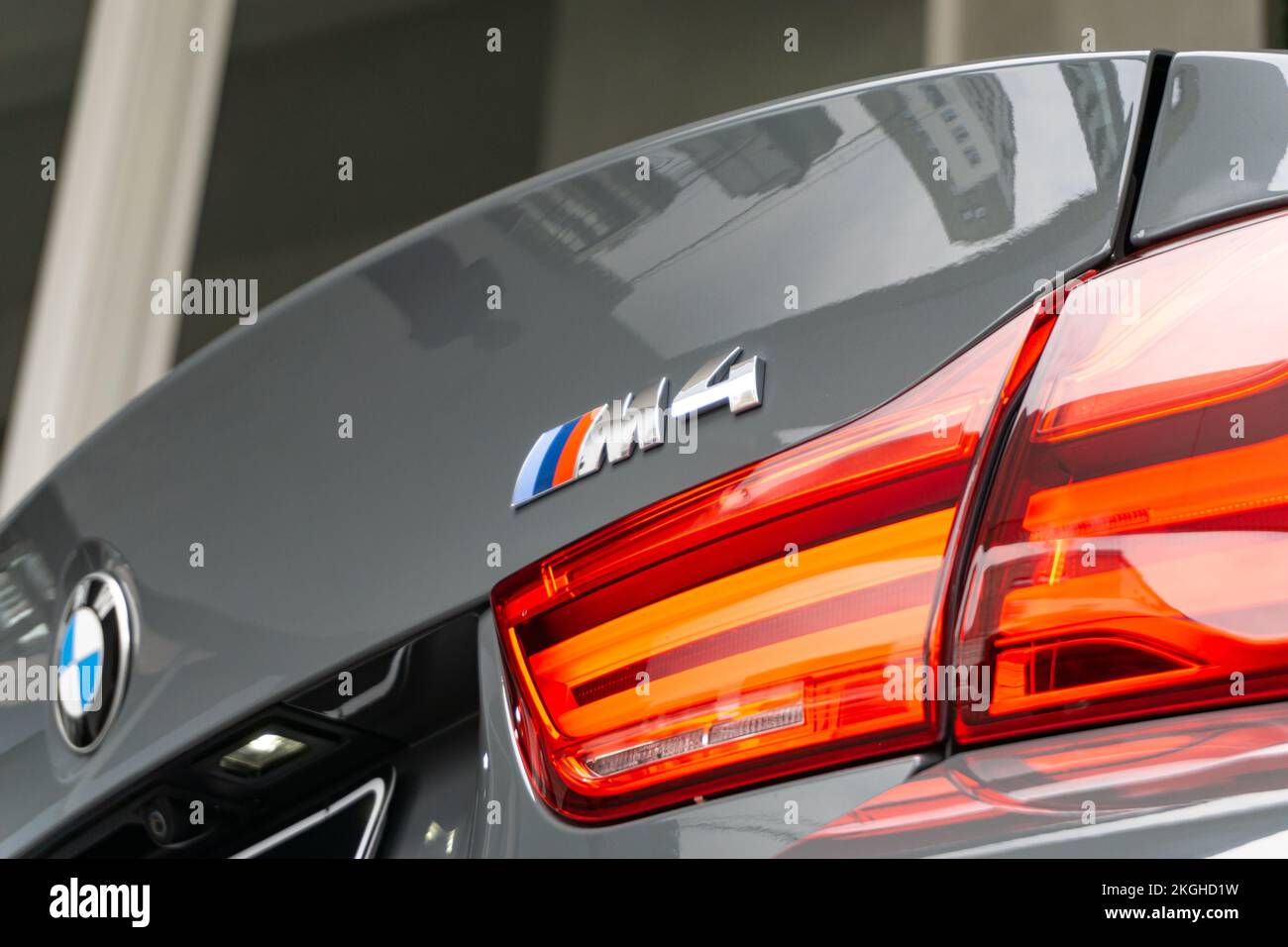 A closeup shot of a BMW M4 with a gray "M4" logo Stock Photo - Alamy
