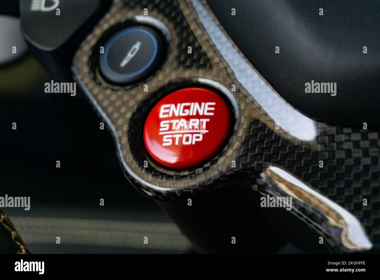 A closeup shot of details on an engine start and stop button in a ...
