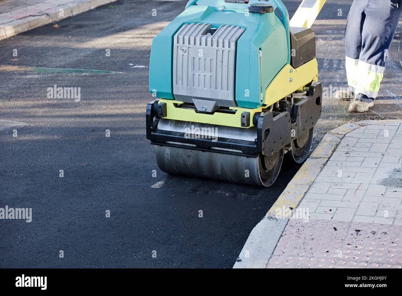 Road construction equipment flattening and smoothing asphalt black top ...
