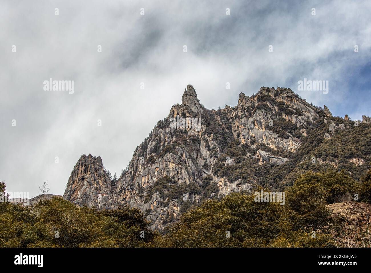 A landscape steep rocky peaks with green trees in Tibet Stock Photo - Alamy