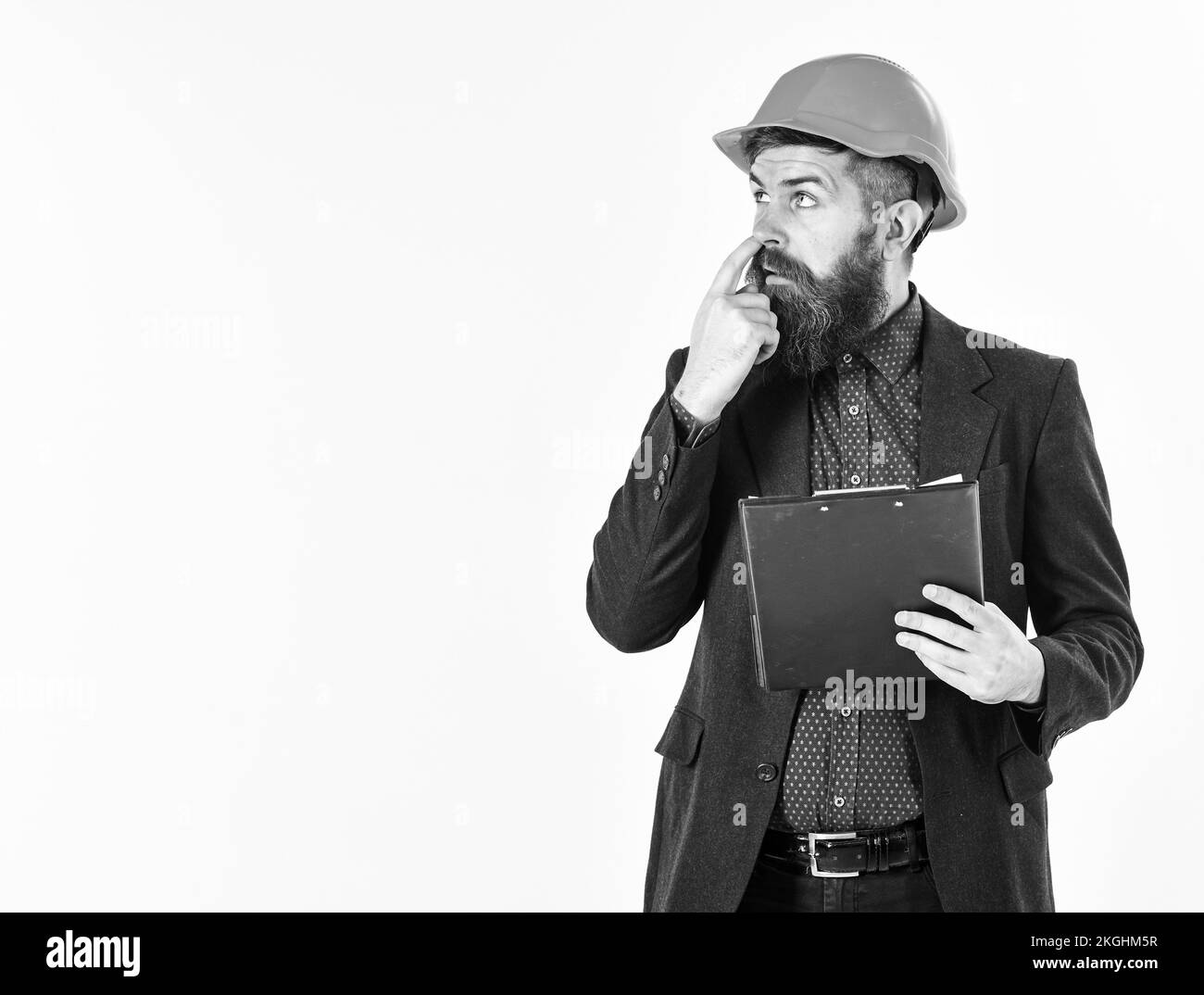 Inspector wears construction helmet. Building inspector with thoughtful ...