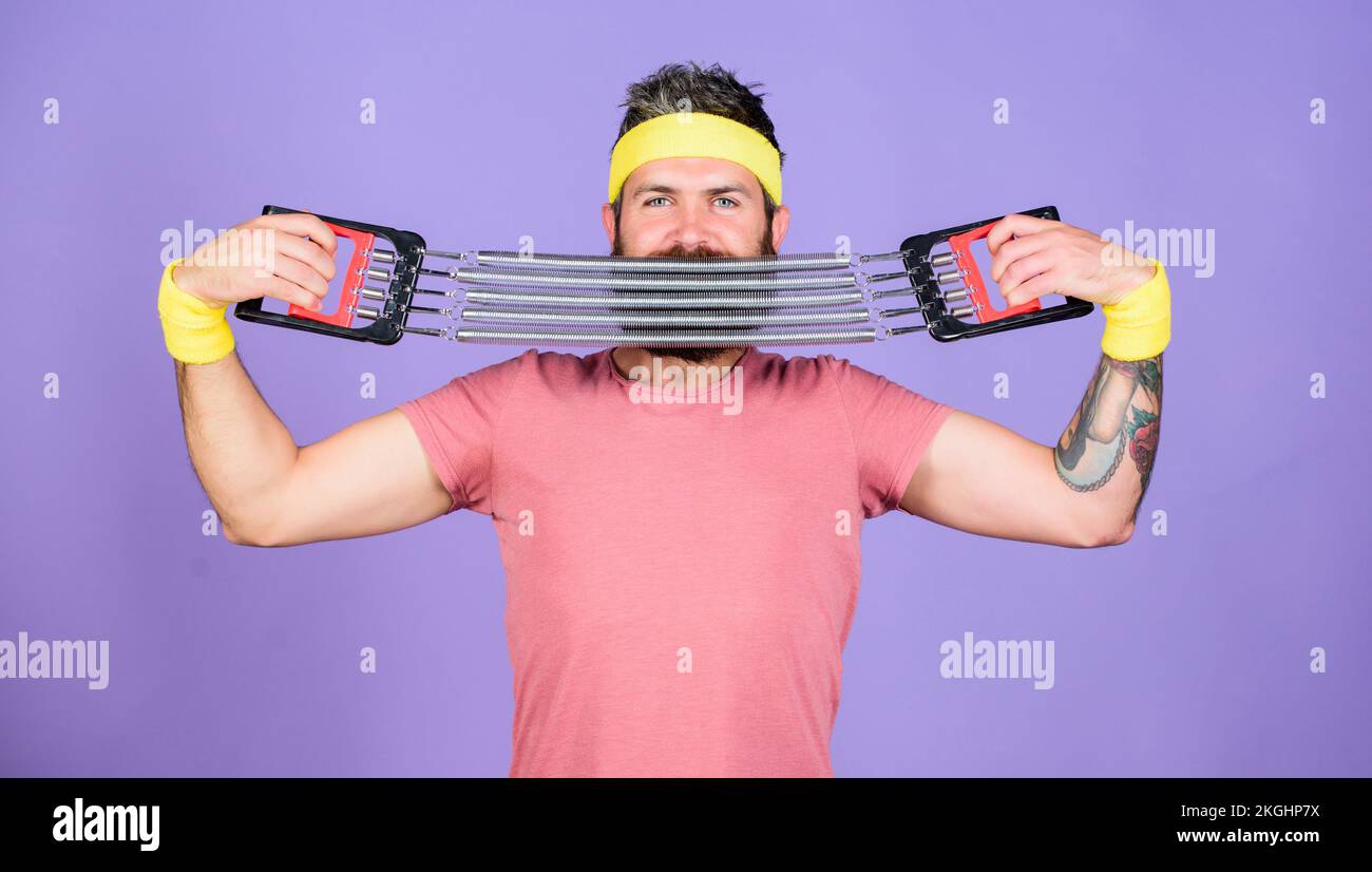 Athlete training with chest expander. Man bearded athlete exercising ...