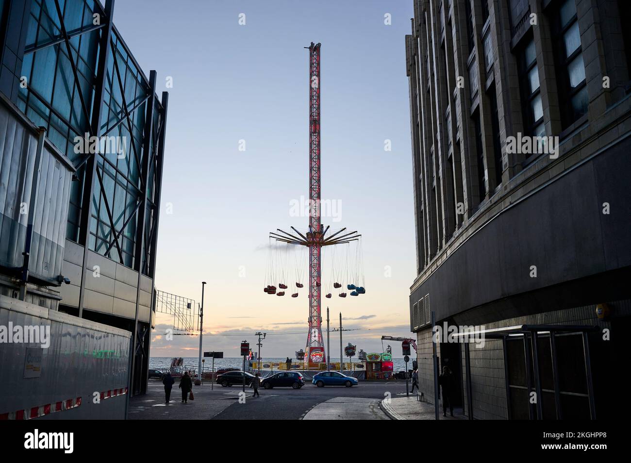 Star flyer ride on Blackpool Promenade at dusk seen between two ...