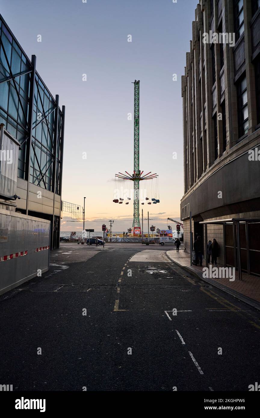 Star flyer ride on Blackpool Promenade at dusk seen between two ...