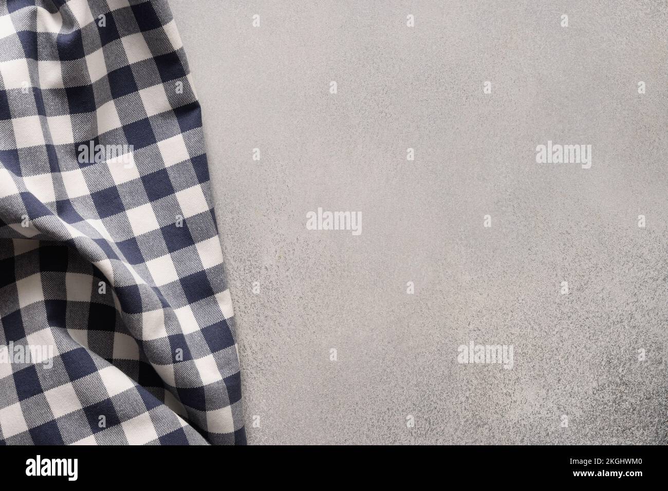 Kitchen gray table top with blue checkered towel. Top view. Flat lay ...