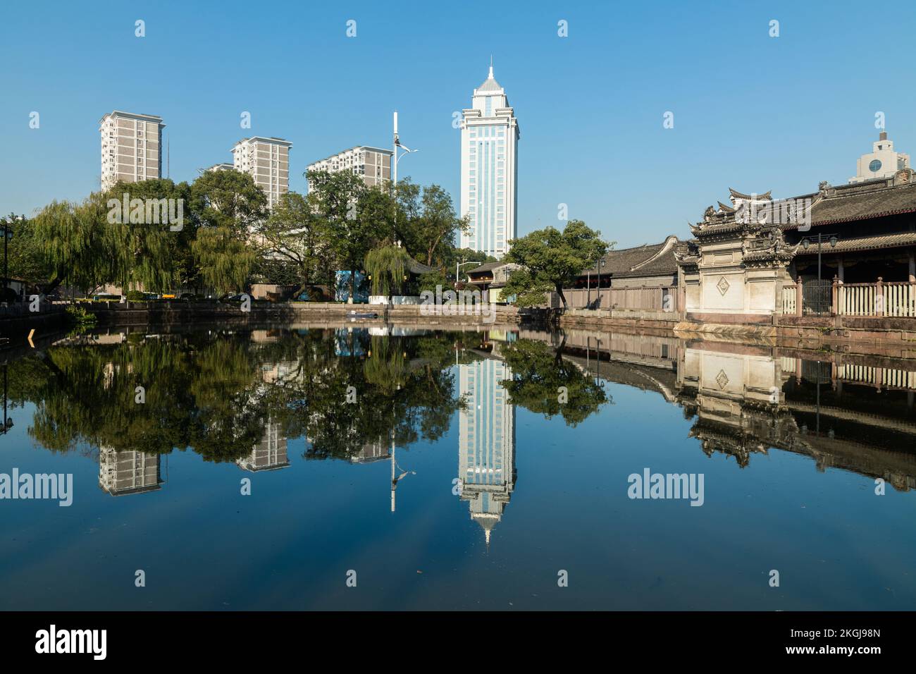 The Chengdu cityscape with water reflecting buildings and clear sunlit ...