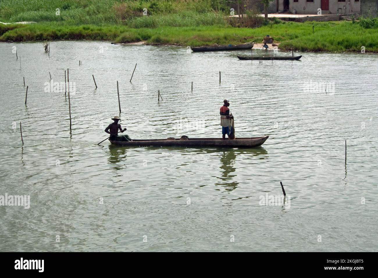 View of Lake Aheme with some fishermen in canoes on the lake, Benin ...