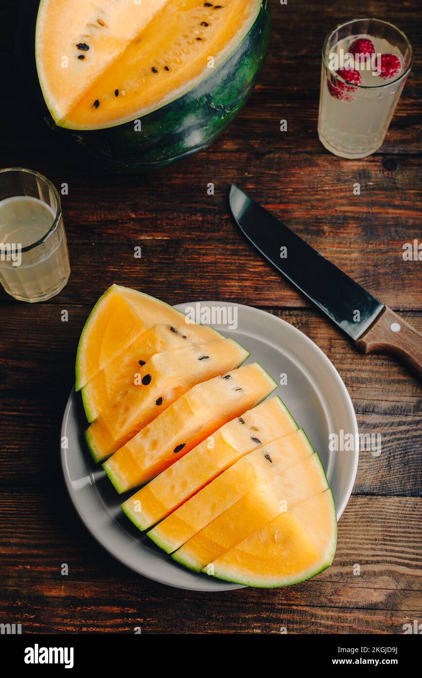Sliced Yellow Watermelon on a Wooden Table Stock Photo - Alamy