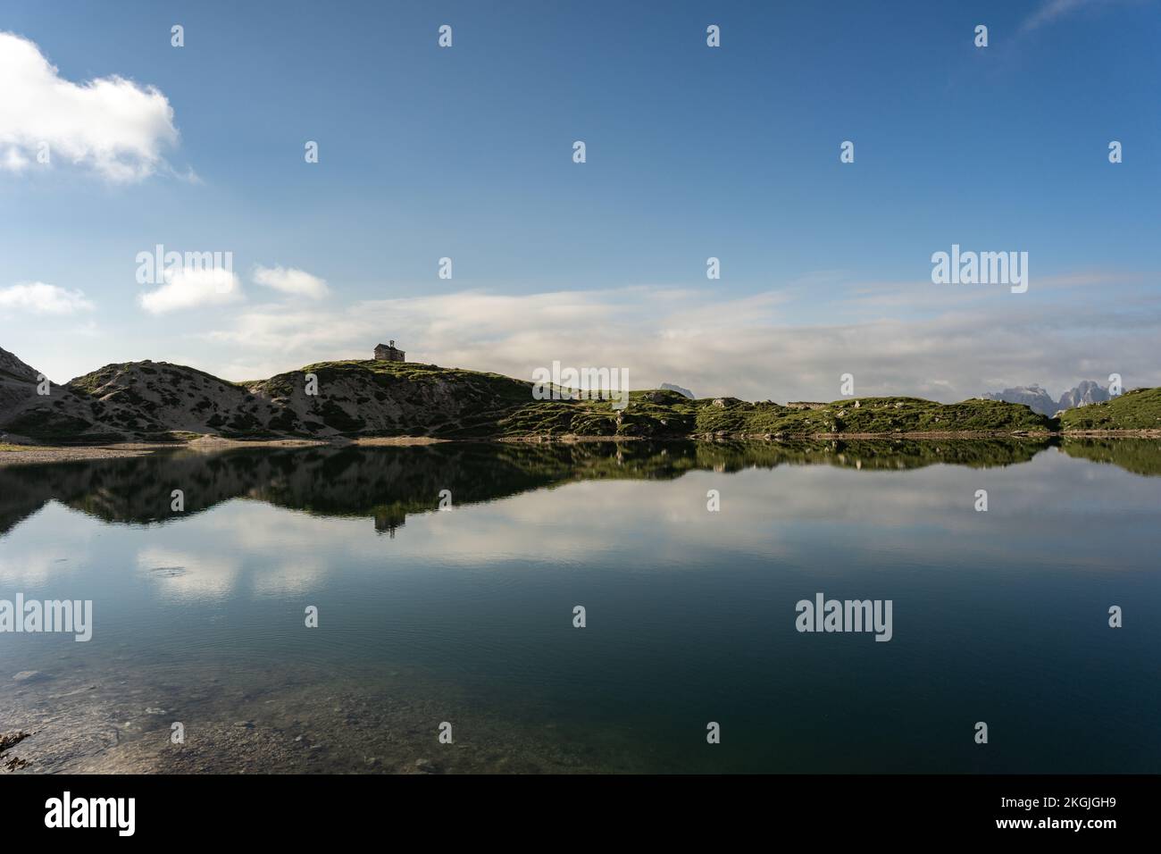 Picturesque hills relfecting on the Olbe Lakes water surface, italy ...
