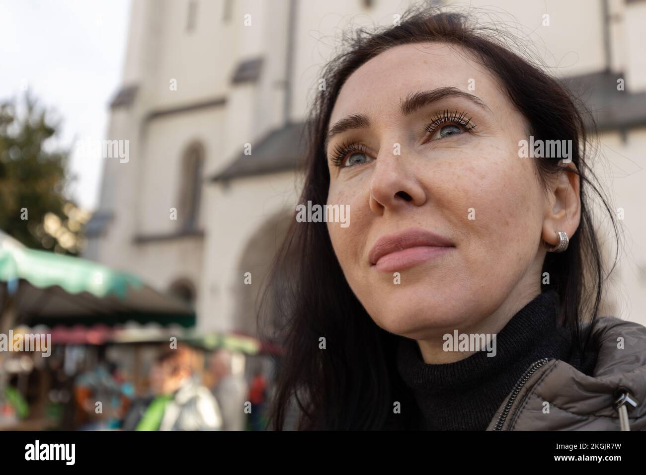 Large female portrait against the background of a tall building ...