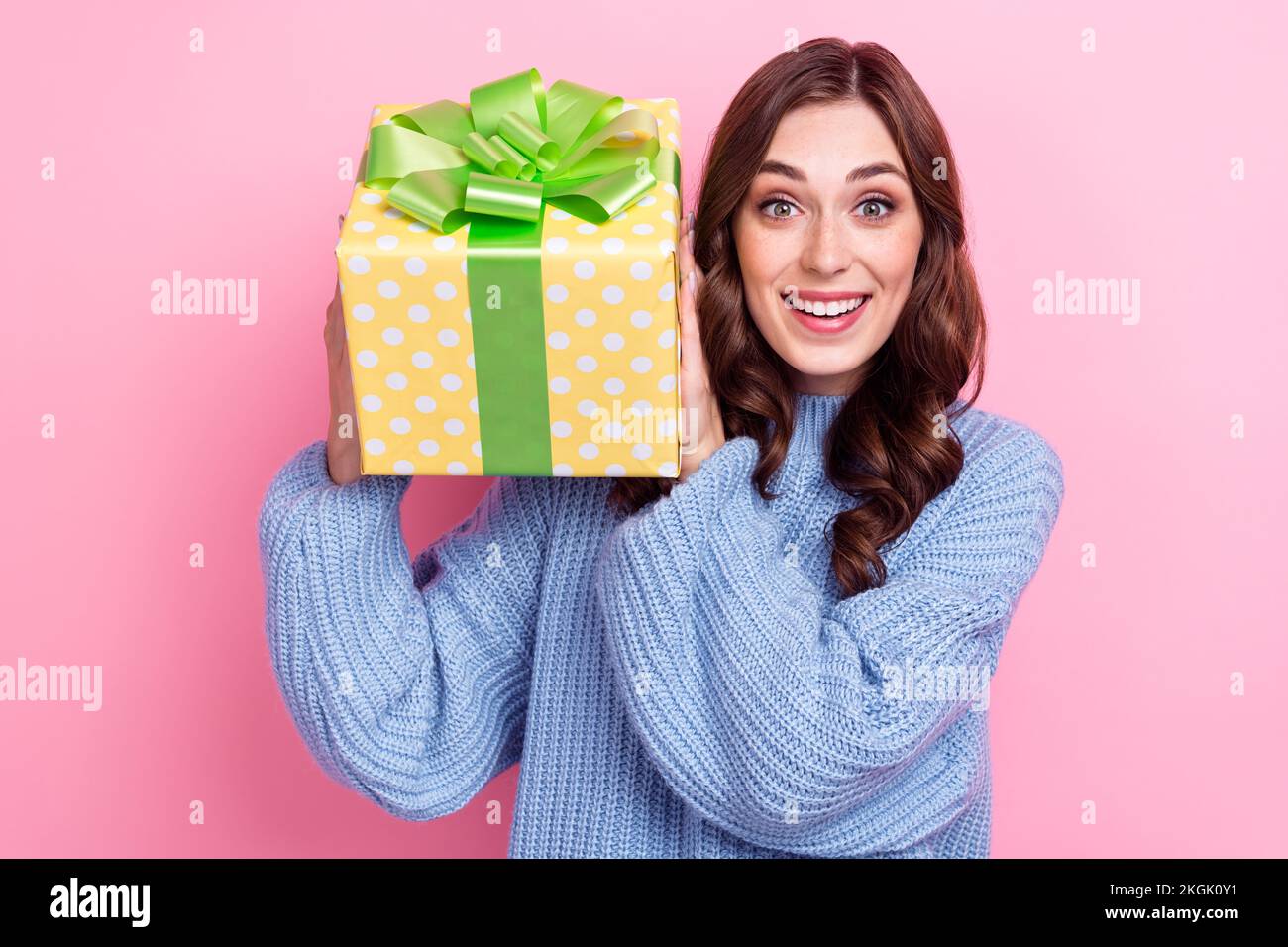 Portrait of funny cheerful girl hands hold receive giftbox toothy smile ...