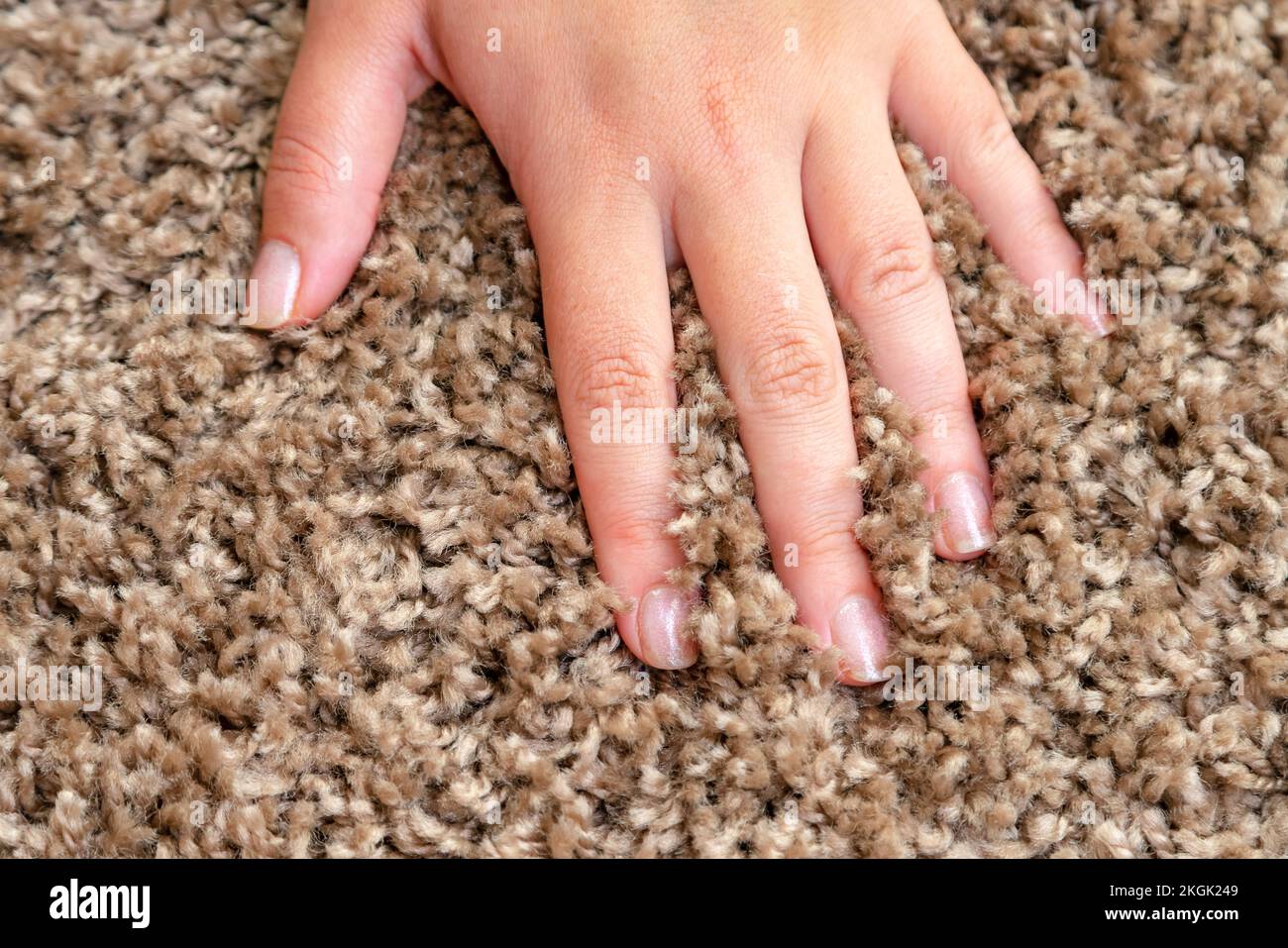 Close up of hand touching soft carpet. Gentle and fluffy carpet between ...