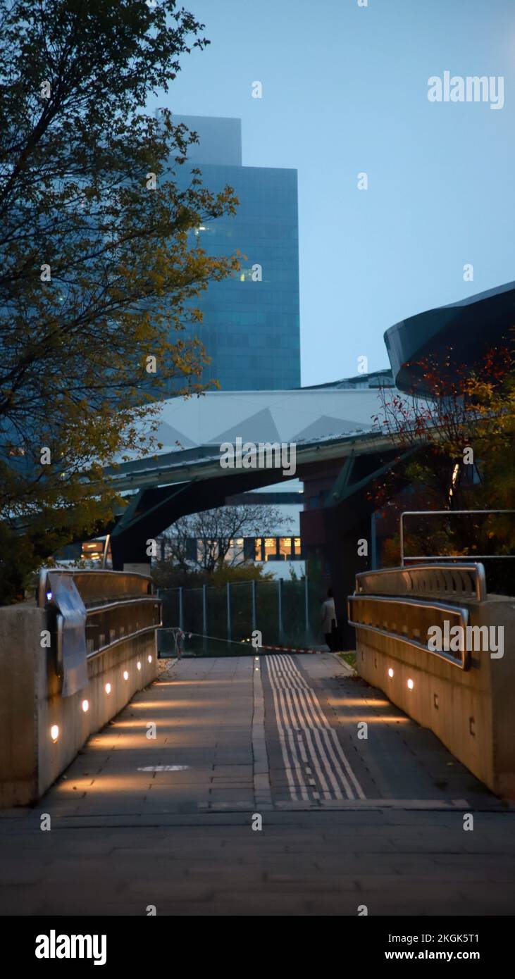 Small modern pedestrian bridge with lights in the evening Stock Photo ...