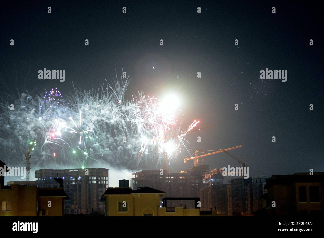 colorful fireworks at night with shadows of a construction site and ...