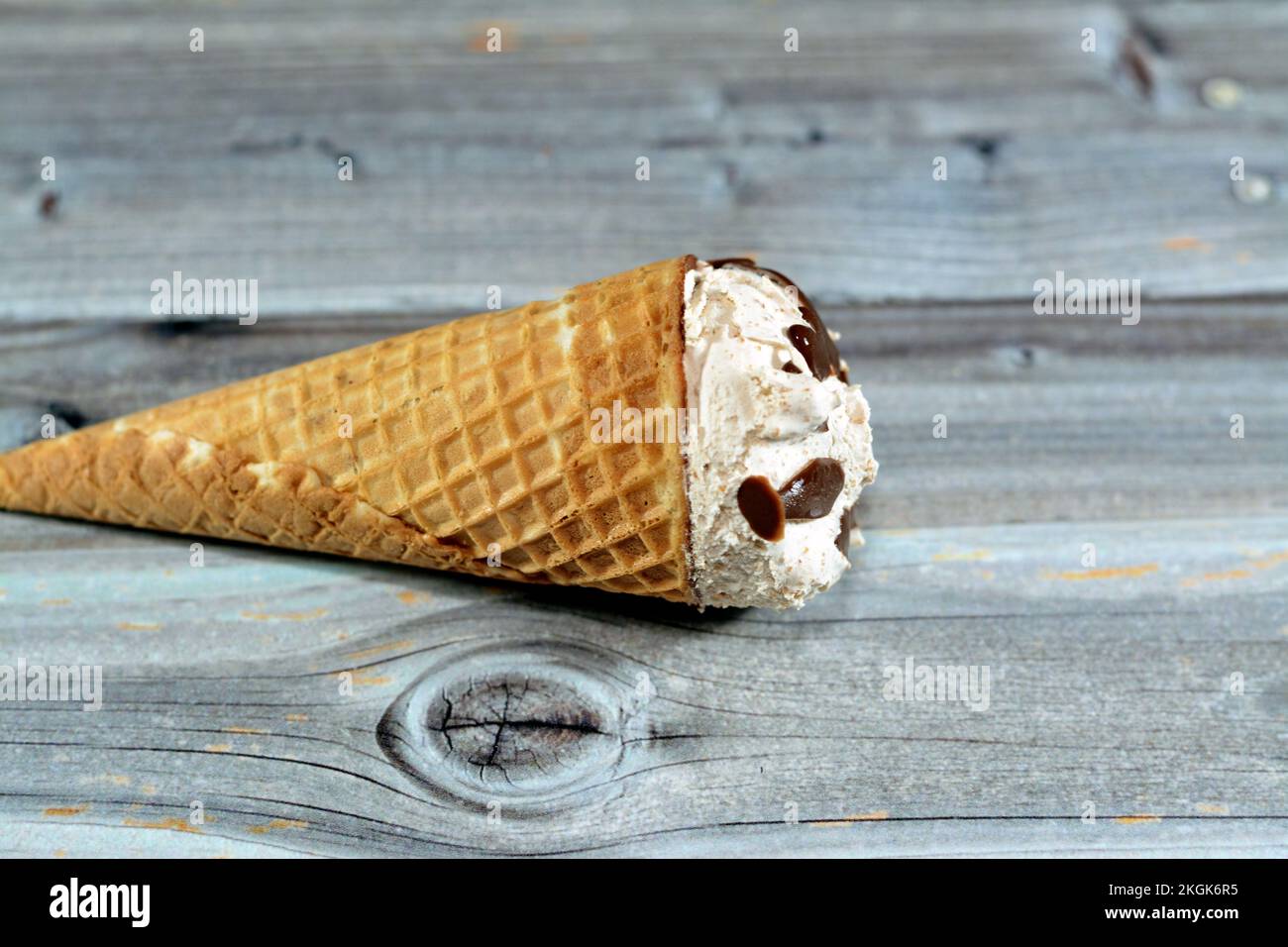 Ice cream vanilla cone with topping of chocolate chips pieces in a ...
