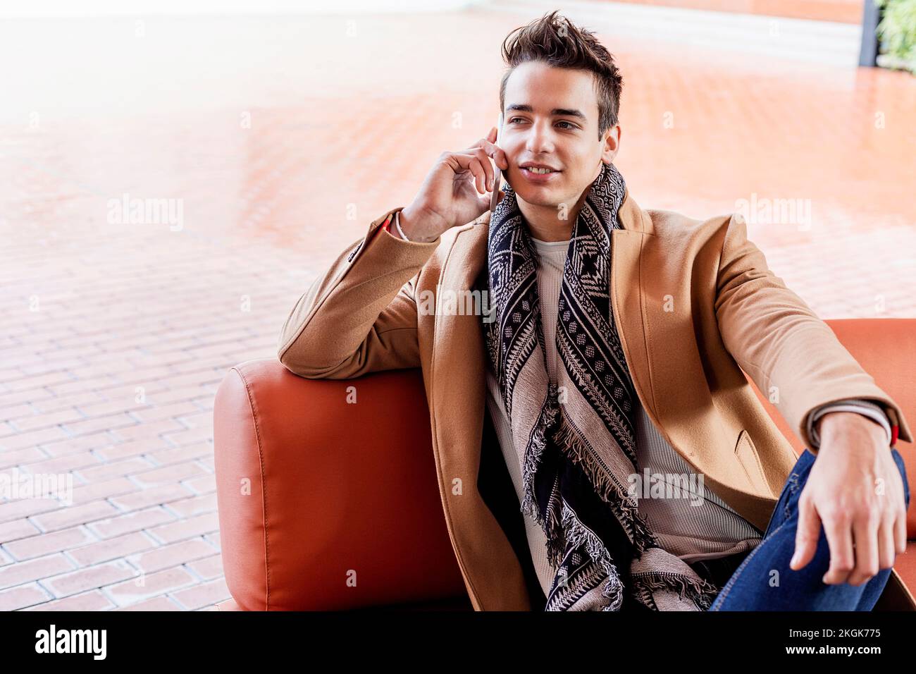 Young man wearing winter clothes in the street. Young guy with modern ...