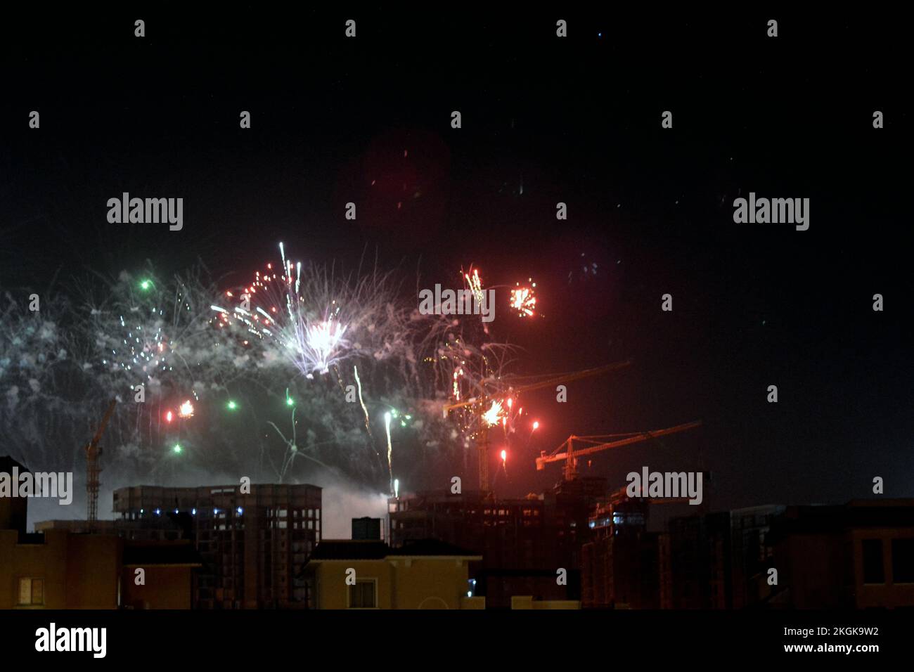 colorful fireworks at night with shadows of a construction site and ...