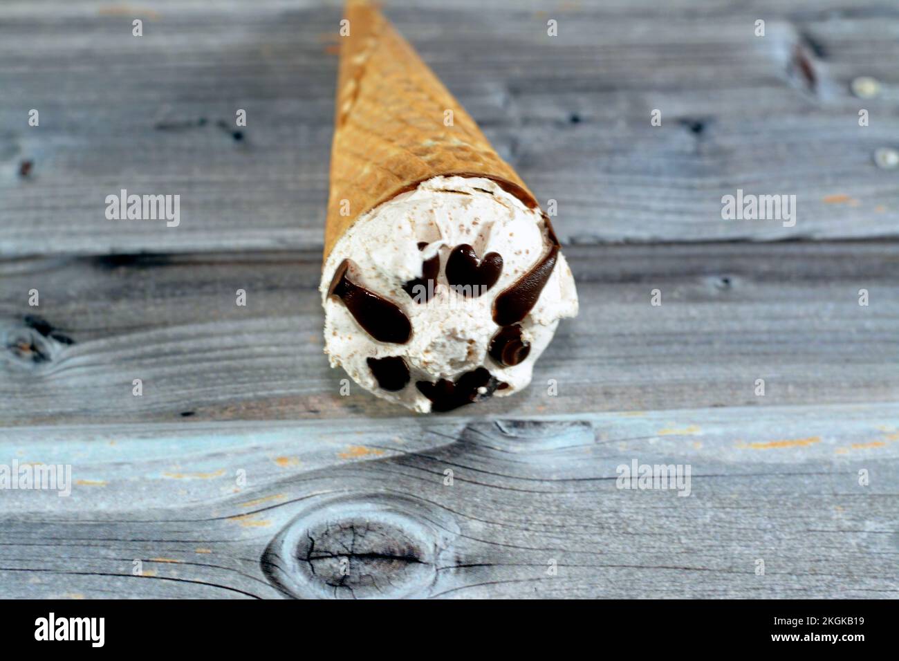 Ice cream vanilla cone with topping of chocolate chips pieces in a ...