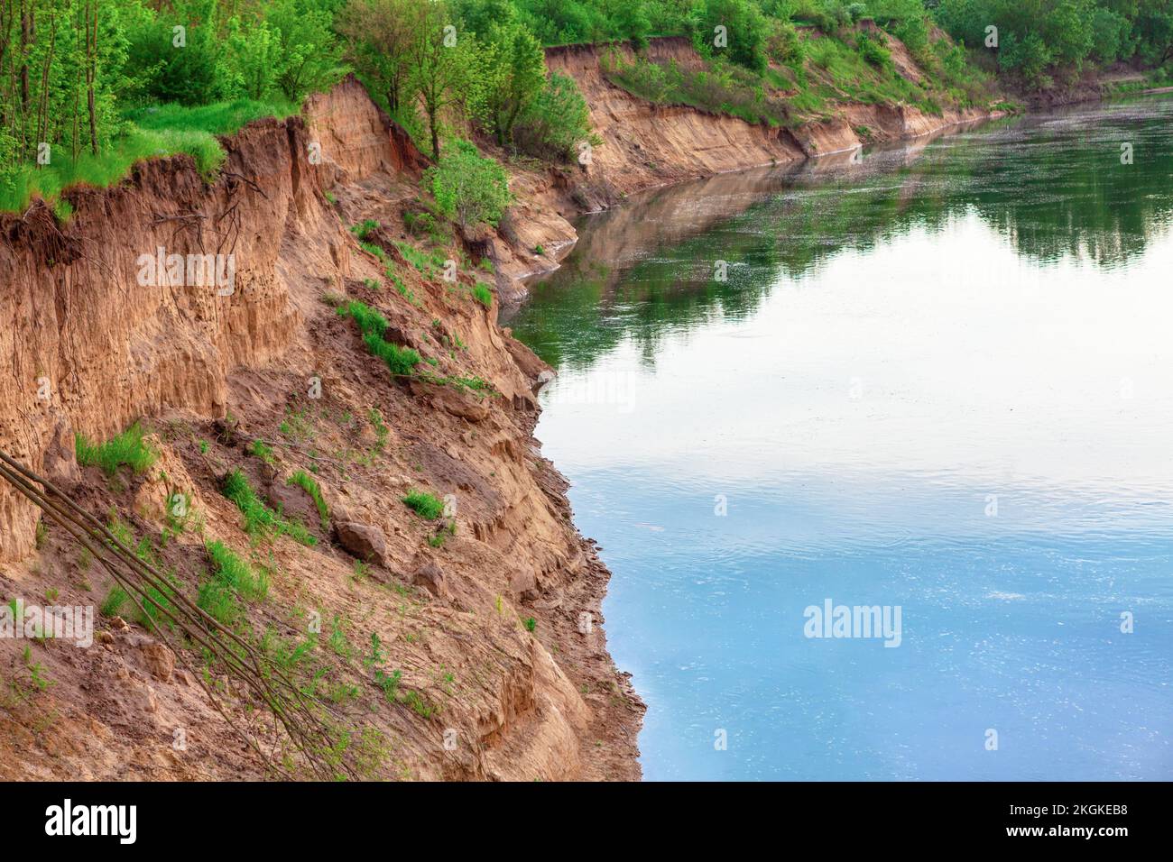 Clay coastal cliff , wilderness nature and flowing river Stock Photo ...
