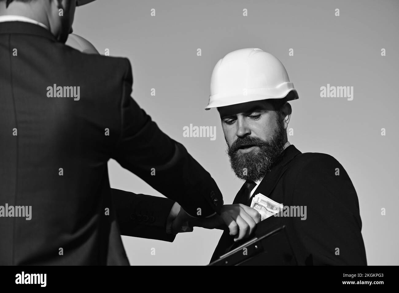 Builders make bargain. Architects with confused face in formal wear ...