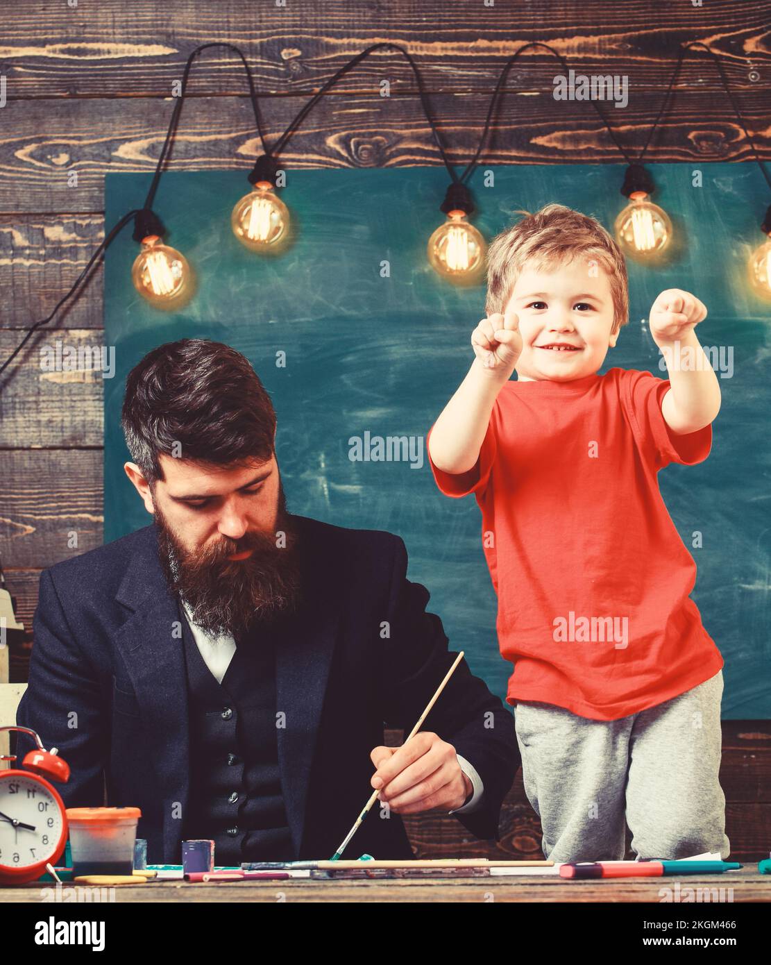 Child cheerful and teacher painting, drawing. Art lesson concept ...