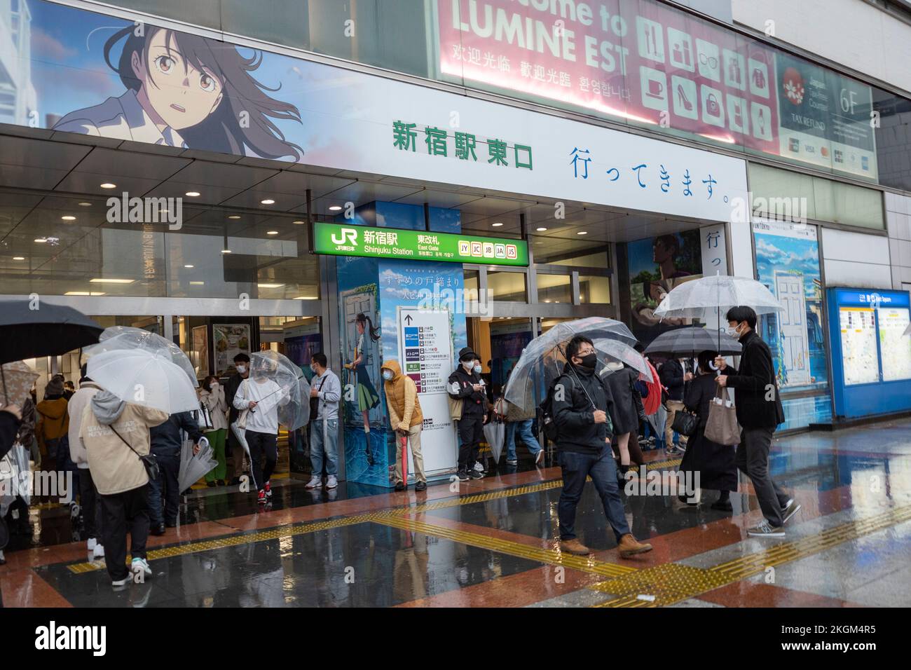 Tokyo, Japan. 23rd Nov, 2022. Commuters pack their umbrellas while ...